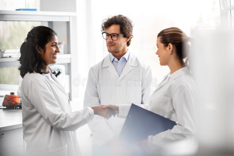 Scientists Shaking Hands in Laboratory Stock Photo - Image of shaking ...