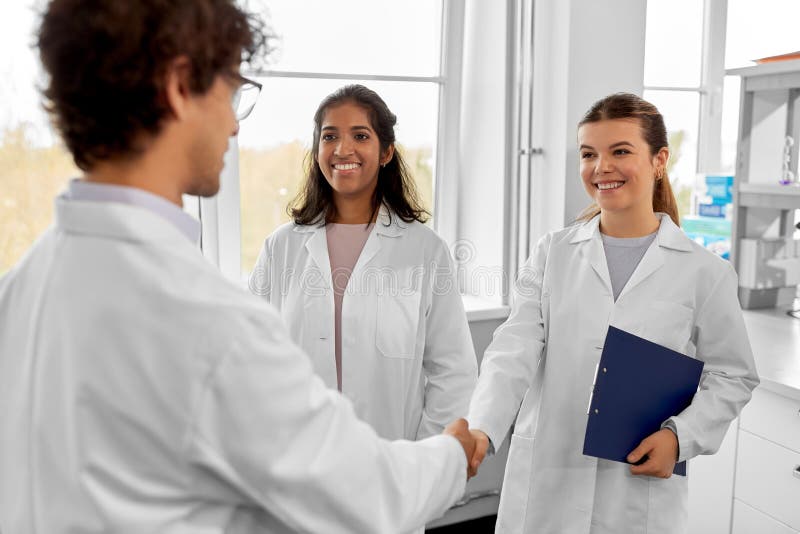 Scientists Shaking Hands in Laboratory Stock Photo - Image of greeting ...