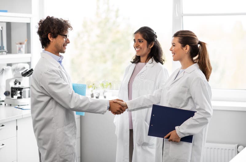 Scientists Shaking Hands in Laboratory Stock Photo - Image of science ...
