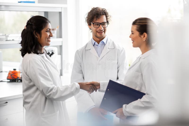 Scientists Shaking Hands in Laboratory Stock Image - Image of agreement ...
