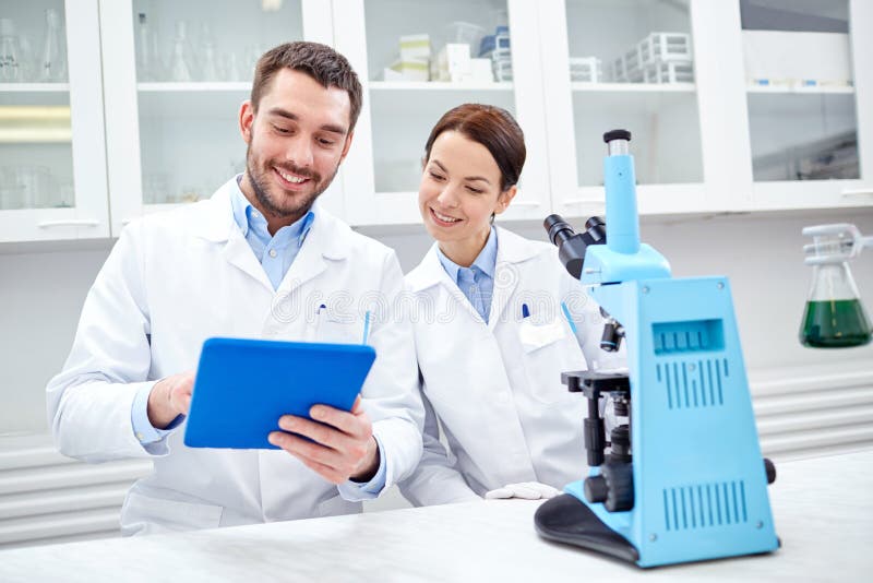 Scientists with Tablet Pc and Microscope in Lab Stock Photo - Image of ...
