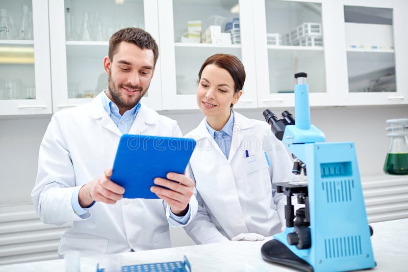 Scientists with Tablet Pc and Microscope in Lab Stock Image - Image of ...