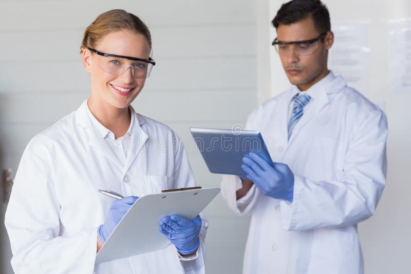 Two Scientists Observing Something with Microscope Stock Photo - Image ...