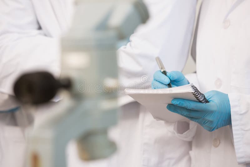 Scientists taking notes stock image. Image of biochemist - 53088019