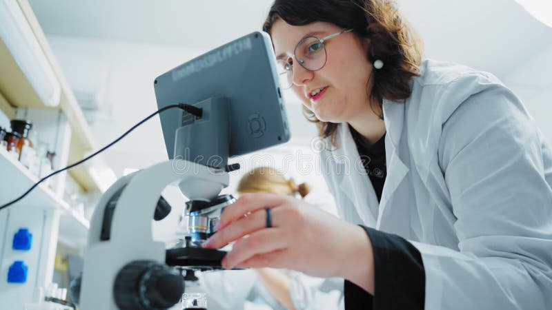 Scientists Using Microscope in Bio Lab and Experiment, Concept Science ... Scientists Using Microscope in Bio Lab and Experiment, Concept Science ...