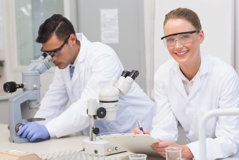 Scientists Using Microscope Stock Image - Image of medical, dish: 53088947