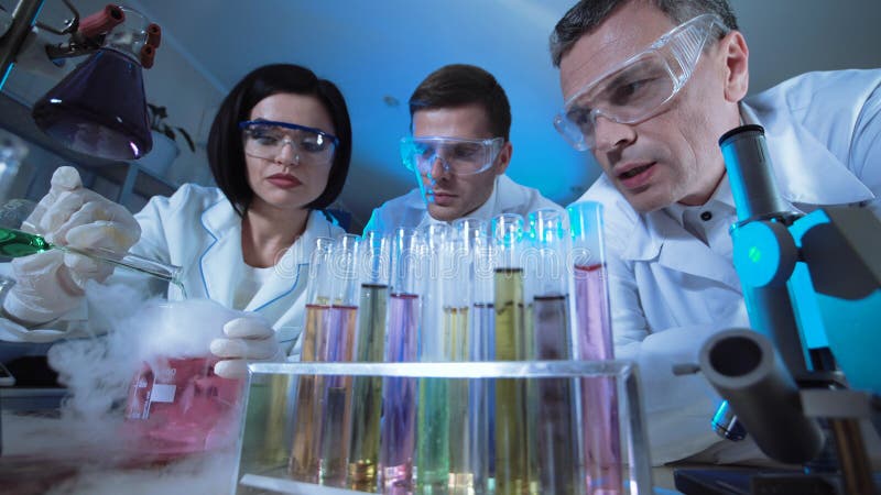 Scientists Watching Reactions in Test Tubes Stock Image - Image of ...