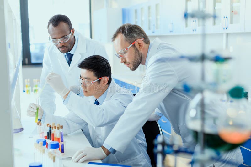 Scientists in White Coats Working Together in Chemical Laboratory Stock ...