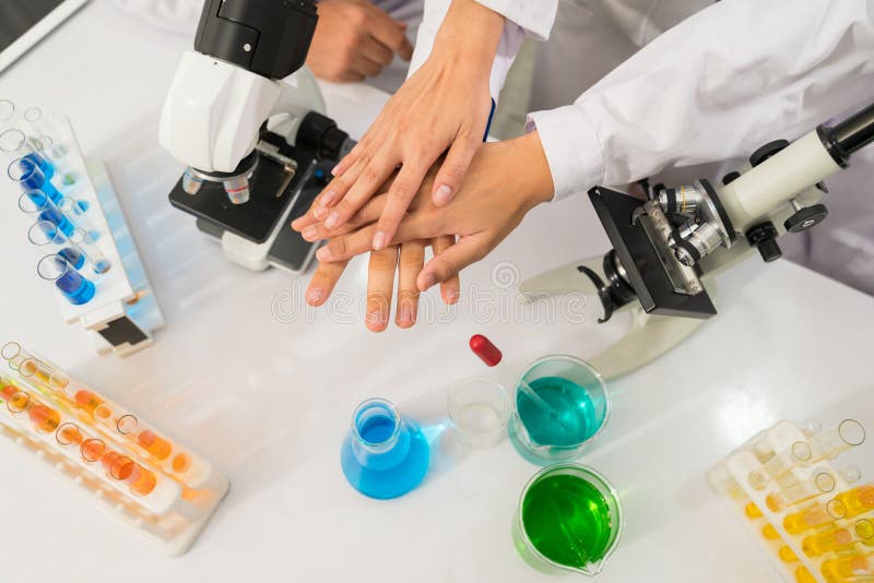 Group of Scientists Team Join Hands with Laboratory Microscopes ...