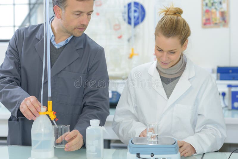Scientists at work in lab stock image. Image of scientific - 161226067
