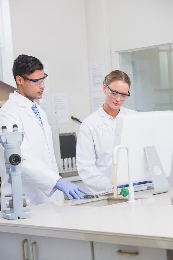 Scientists Working on Computer Together Stock Image - Image of ...