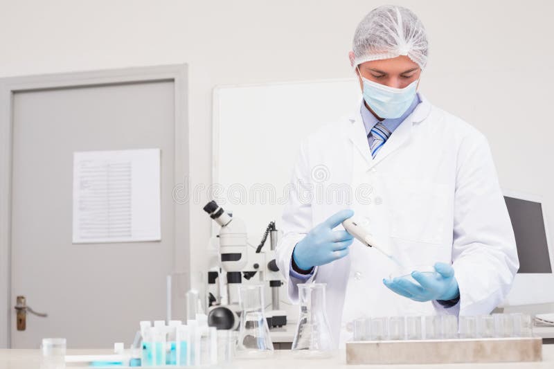 Adjustable Pipette Dispensing Blue Liquid into Test Tube Rack on ...