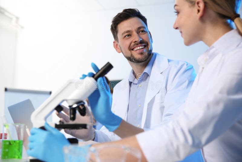 Scientists Working at Table in Chemistry Laboratory Stock Image - Image ...