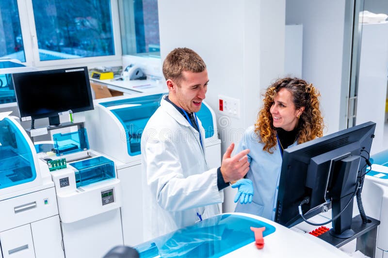 Scientists Working Using Computer in a Modern Laboratory of an Hospital ...
