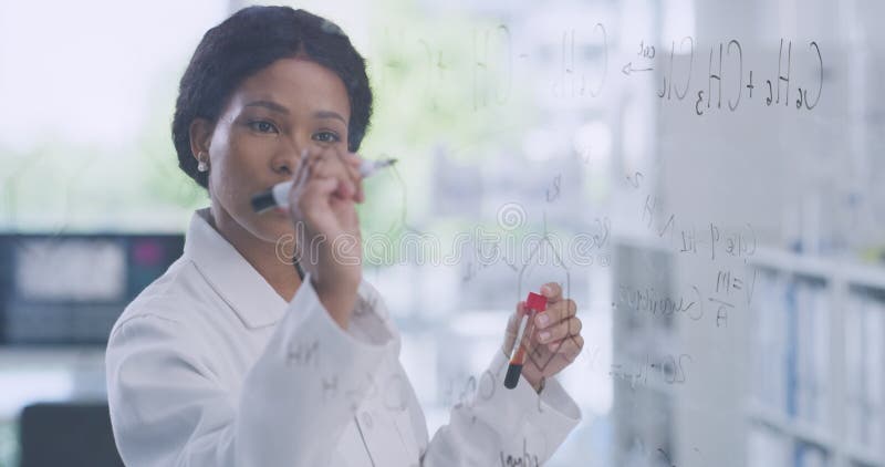 Scientists Writing on Clear Visual Aid Board, Recording Chemical ...