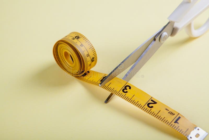 Scissor Cuts Measuring Tape on Yellow Background Stock Image - Image of ...