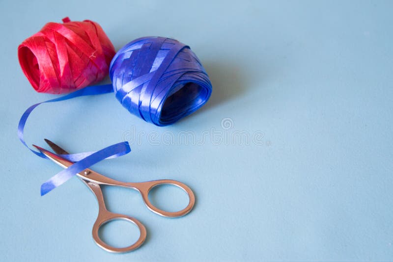 Scissors Cut the Blue Ribbon on Blue Background. Stock Image - Image of ...