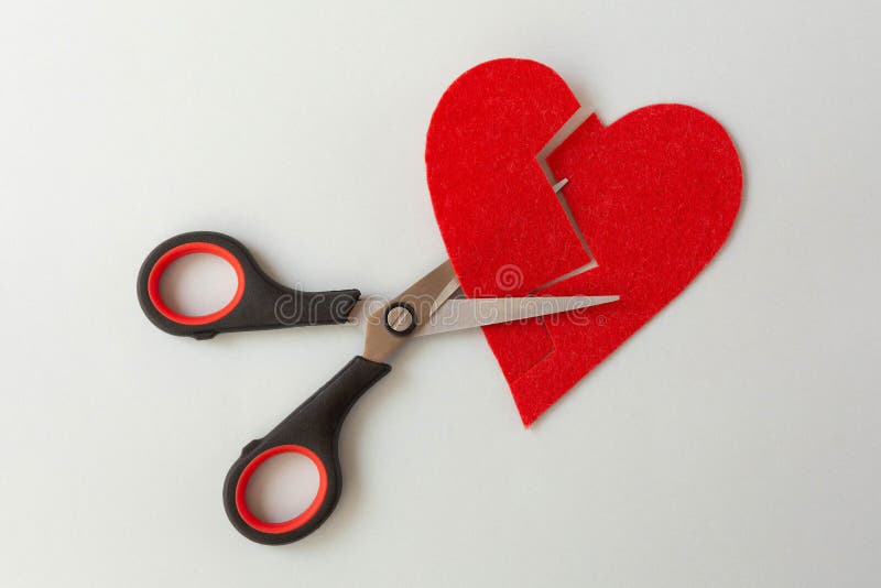 Scissors Cut through the Red Decorative Heart on a Gray Background ...