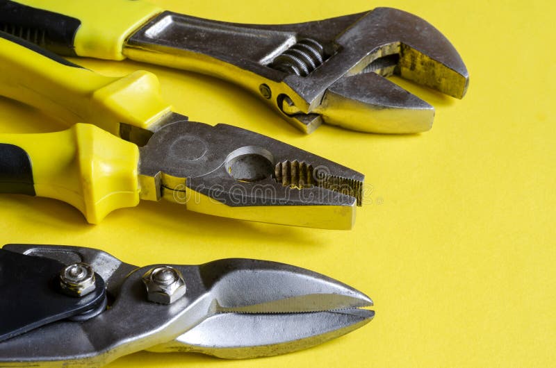 Scissors for Metal, Adjustable Spanner and Pliers in Order on the Table ...