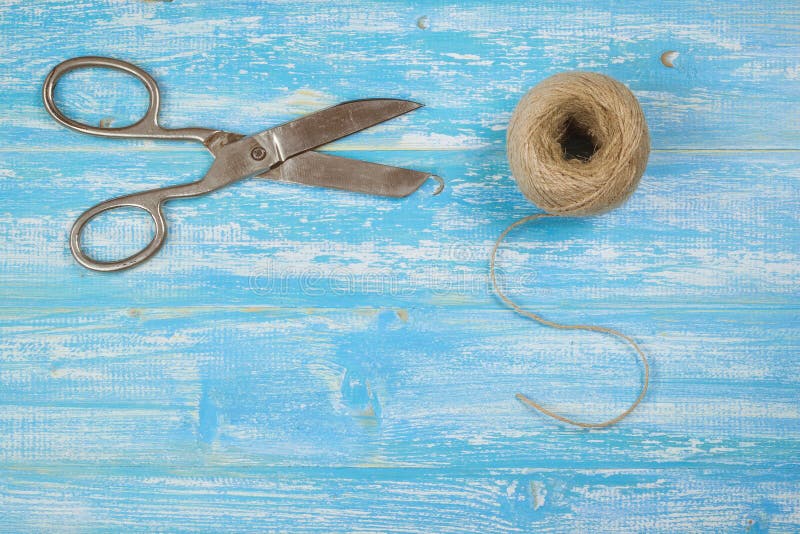 Scissors and a Rough Rope on a Blue Rustic Table. Stock Image - Image ...