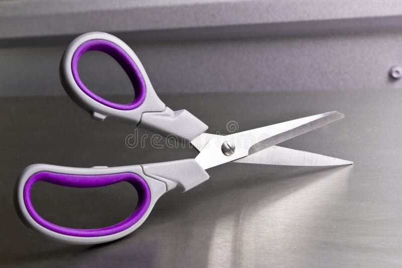 Scissors on steel table stock photo. Image of purple - 15952438