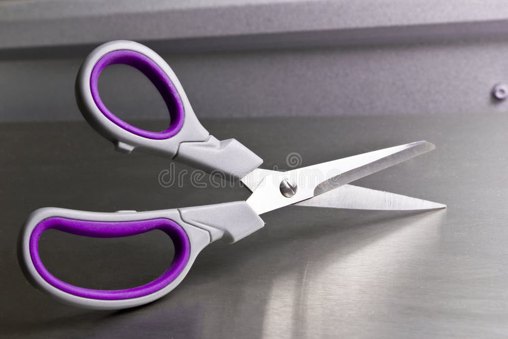 Scissors on steel table stock photo. Image of purple - 15952438
