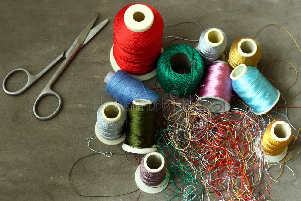 Scissors, Tangled Colored Threads and Bobbins of Thread Stock Photo ...