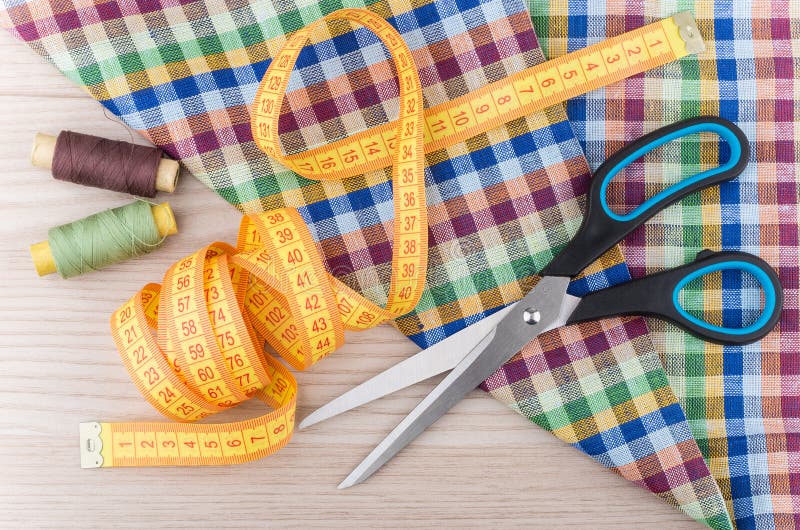 Scissors, Tape-line, Threads and Fabric on Wooden Table Stock Photo ...