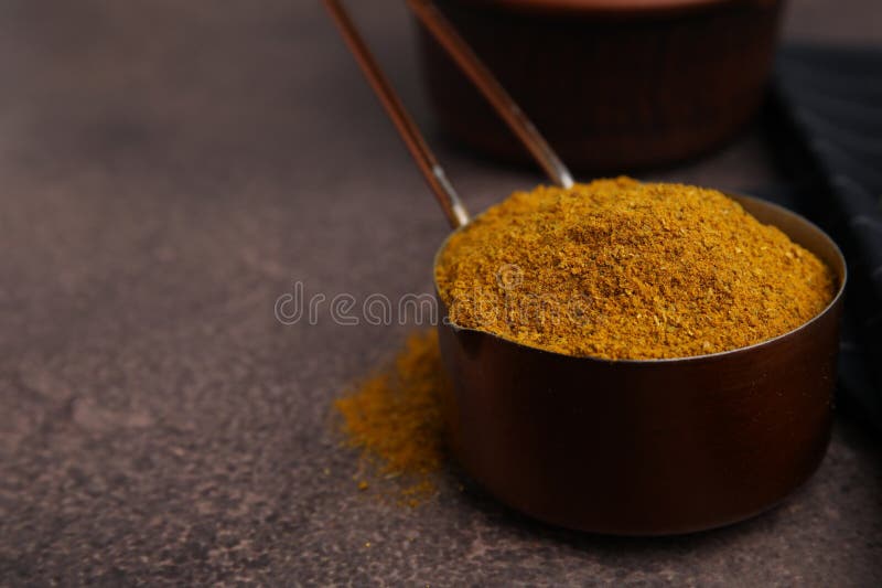 Scoop with Curry Powder on Brown Table, Closeup. Space for Text Stock ...
