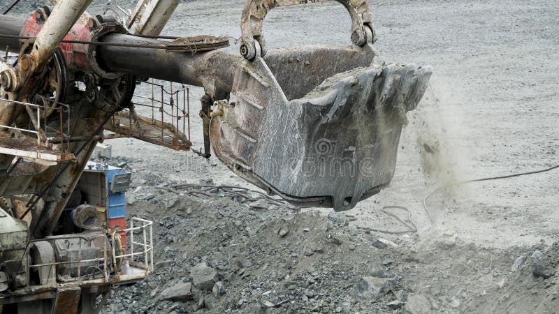 Scoop of Excavator is Digging Hole. Excavator Digs Pit in Ground for ...