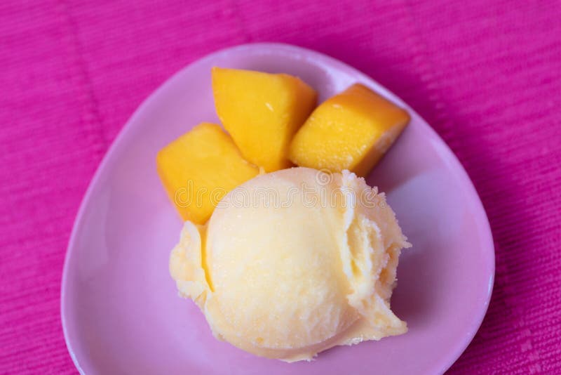 Scoop of Mango Ice Cream from Above with Fresh Mango Pieces Stock Photo ...