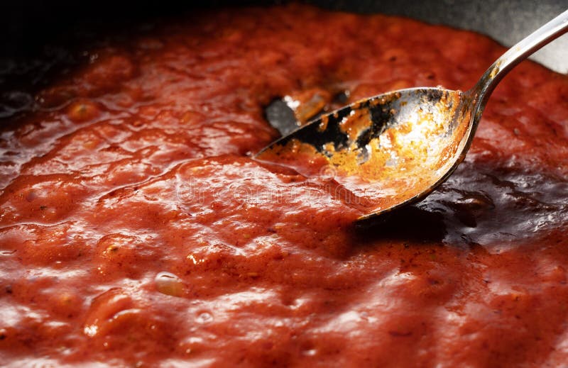 Scoop Up the Tomato Sauce in the Pan with a Spoon Stock Photo - Image ...