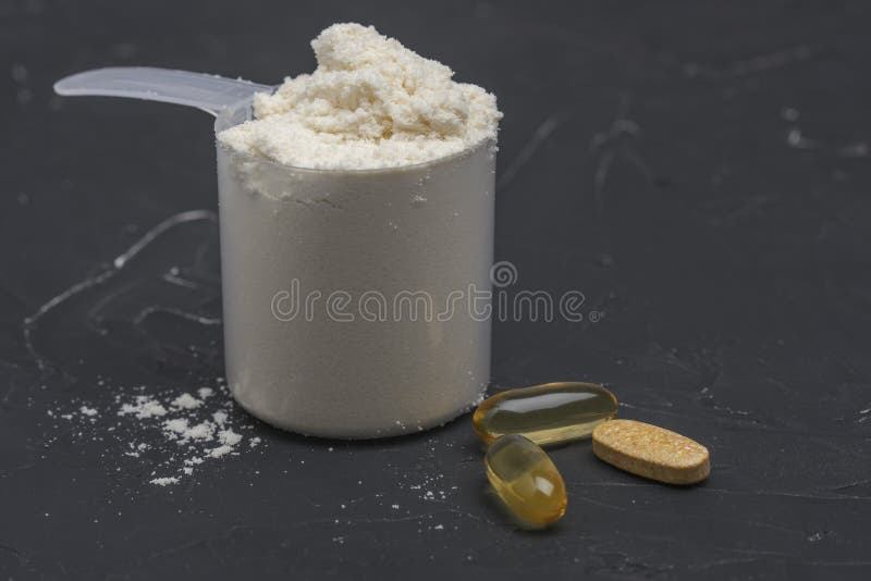 A Scoop of Vanilla Whey Isolate Protein with Fish Oil Capsules and ...