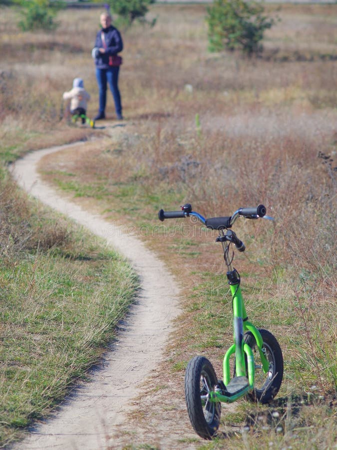 Scooter in the park stock photo. Image of people, motherhood - 263957042