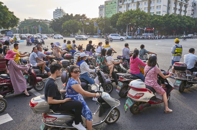 Scooters Drivers Wait for Green Light on an Intersection in Downtown Guilin at Sunrise ...