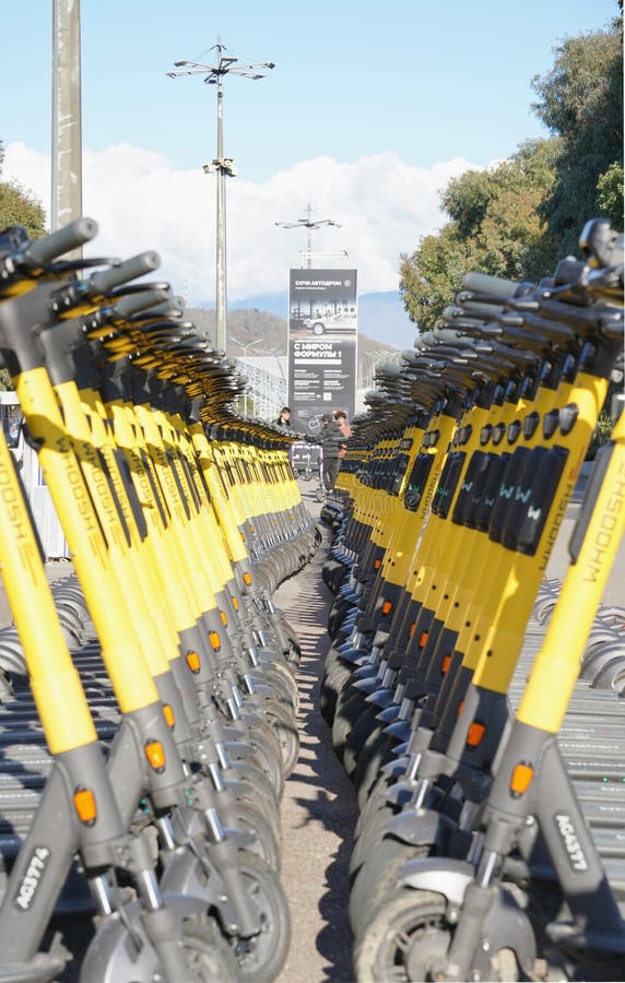 Yellow Electric Scooters for Rent Standing Left and Right in the City ...