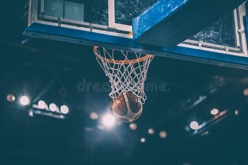 Scoring during a Basketball Game Ball in Hoop Stock Image - Image of ...