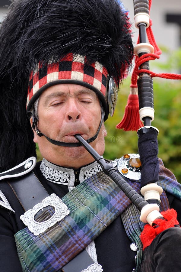 Bagpiper blowing his pipes stock image. Image of instrument - 1076539