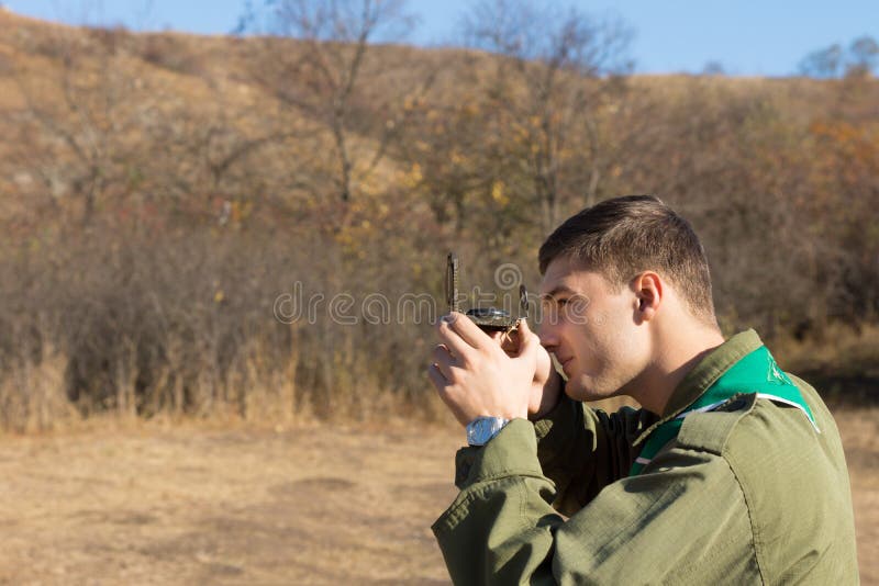 Scout or Ranger Taking a Sighting with a Compass Stock Image - Image of ...
