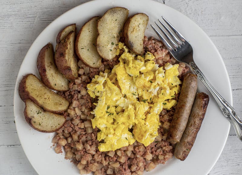 Scrambled Eggs on Corn Beef Hash, with Sausage and Potatoes Stock Image ...