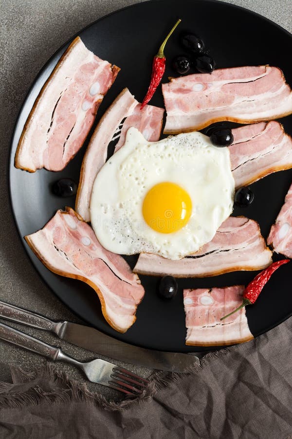 Scrambled Eggs with Bacon on a Black Plate, Top View. an Appetizing ...