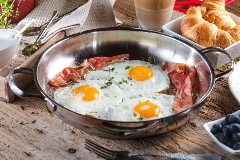 Scrambled Eggs and Bacon on Frying Pan on Table Close-up Stock Image ... Scrambled Eggs and Bacon on Frying Pan on Table Close-up Stock Image ...