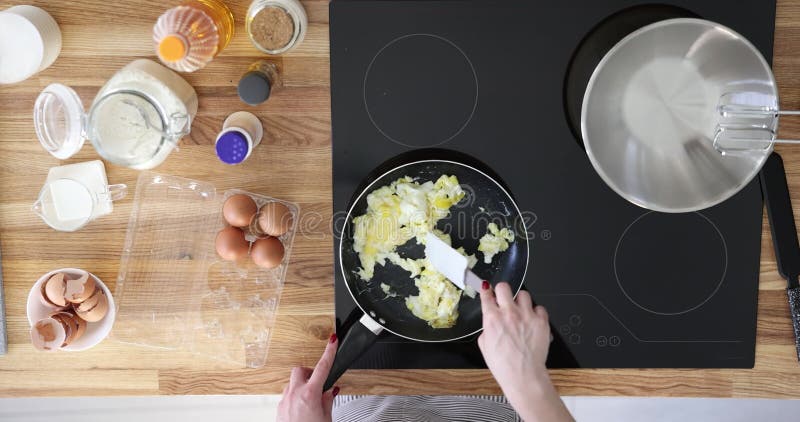 Scrambled Eggs are Being Cooked on Electric Stove in Kitchen Stock ...