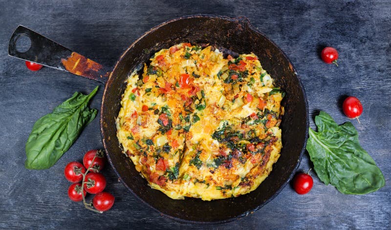 Scrambled Eggs with Tomatoes and Spinach on Rustic Pan Stock Image ...