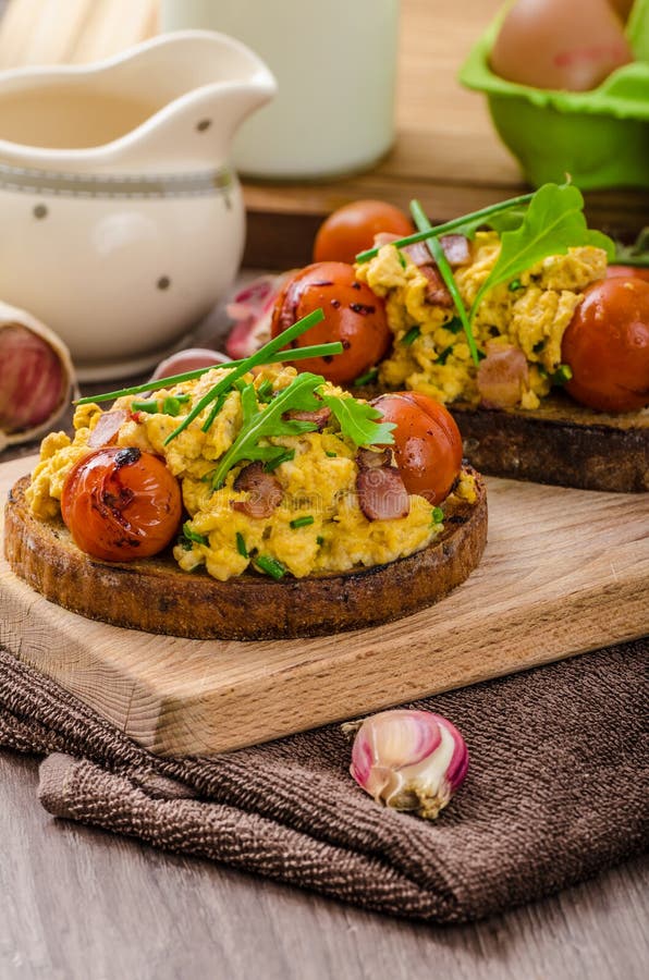 Scrambled Eggs Witch Bacon, Herbs and Tomato Stock Photo - Image of ...