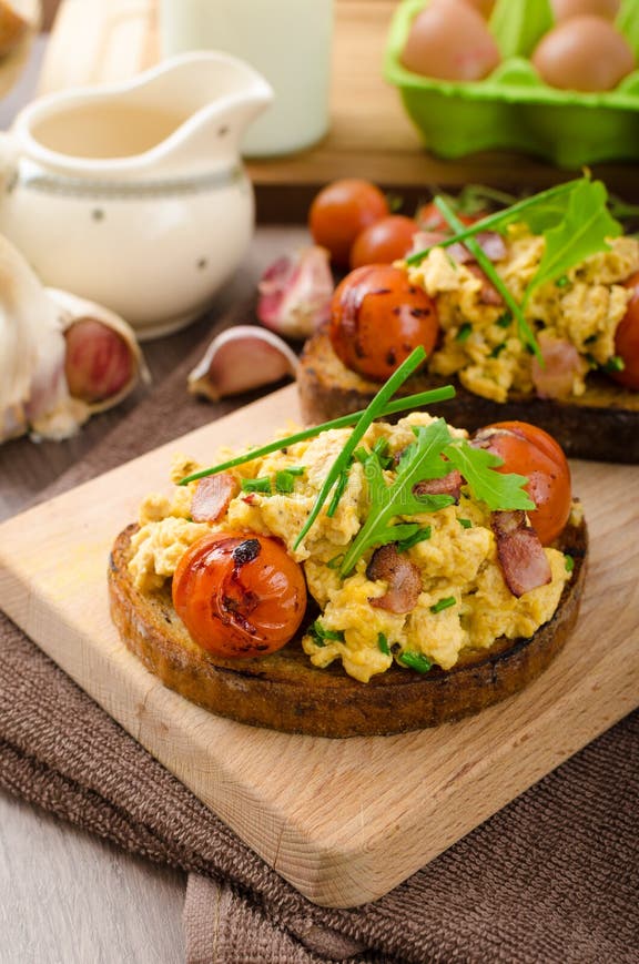 Scrambled Eggs Witch Bacon, Herbs and Tomato Stock Photo - Image of ...