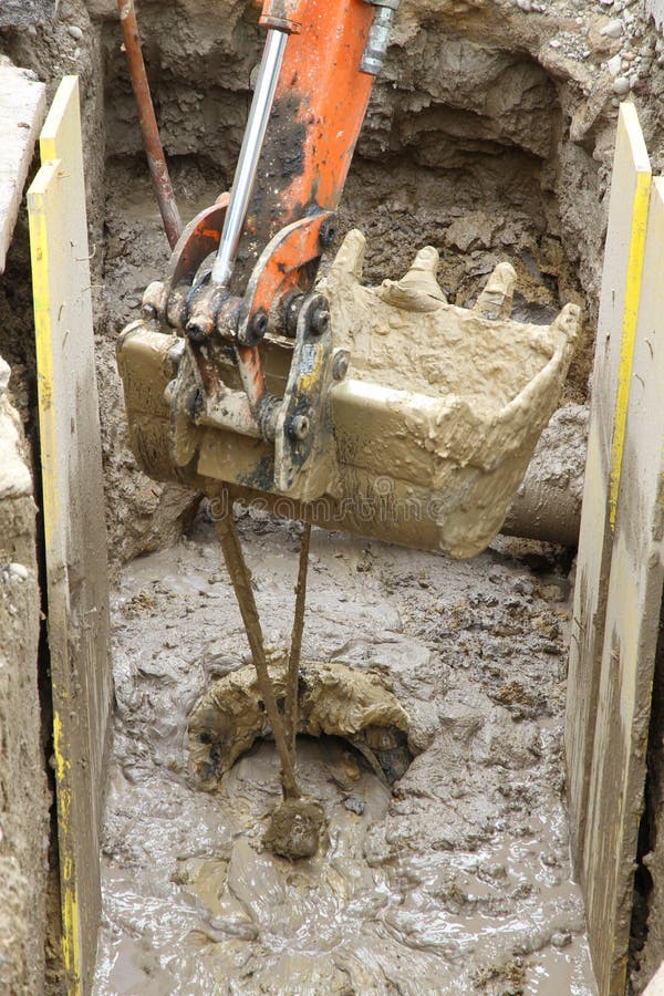 Scraper Bucket during the Work for the Laying of Underground Utilities ...