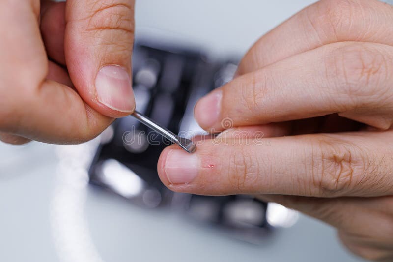 Scraping the Nail with a Tool. a Man Gives Himself a Manicure Stock ...