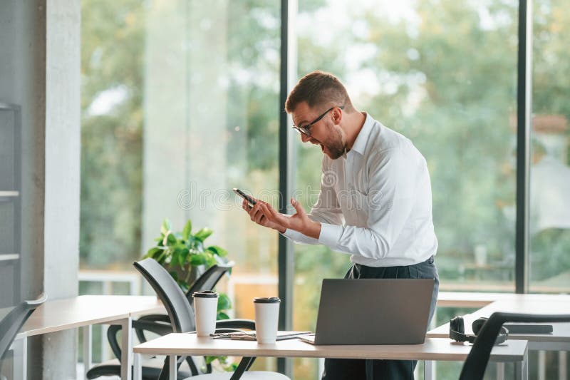 Screaming, Feeling Angry. Man in Formal Clothes is Working in the ...