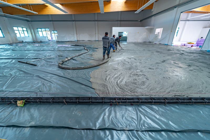 Screed is Poured on a Construction Site Inside a Large Factory Building ...